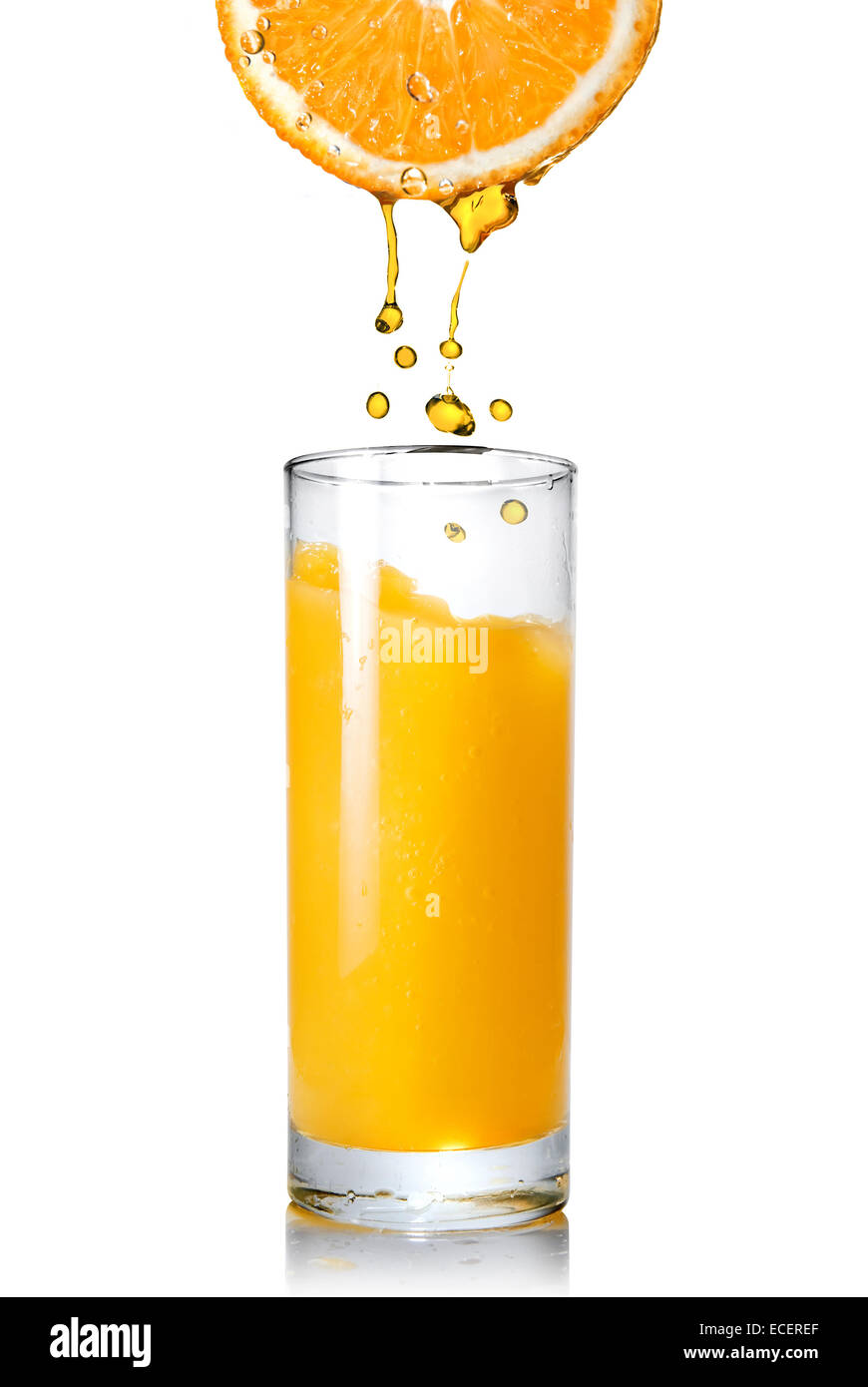 Pouring orange juice from orange into the glass isolated on white Stock ...