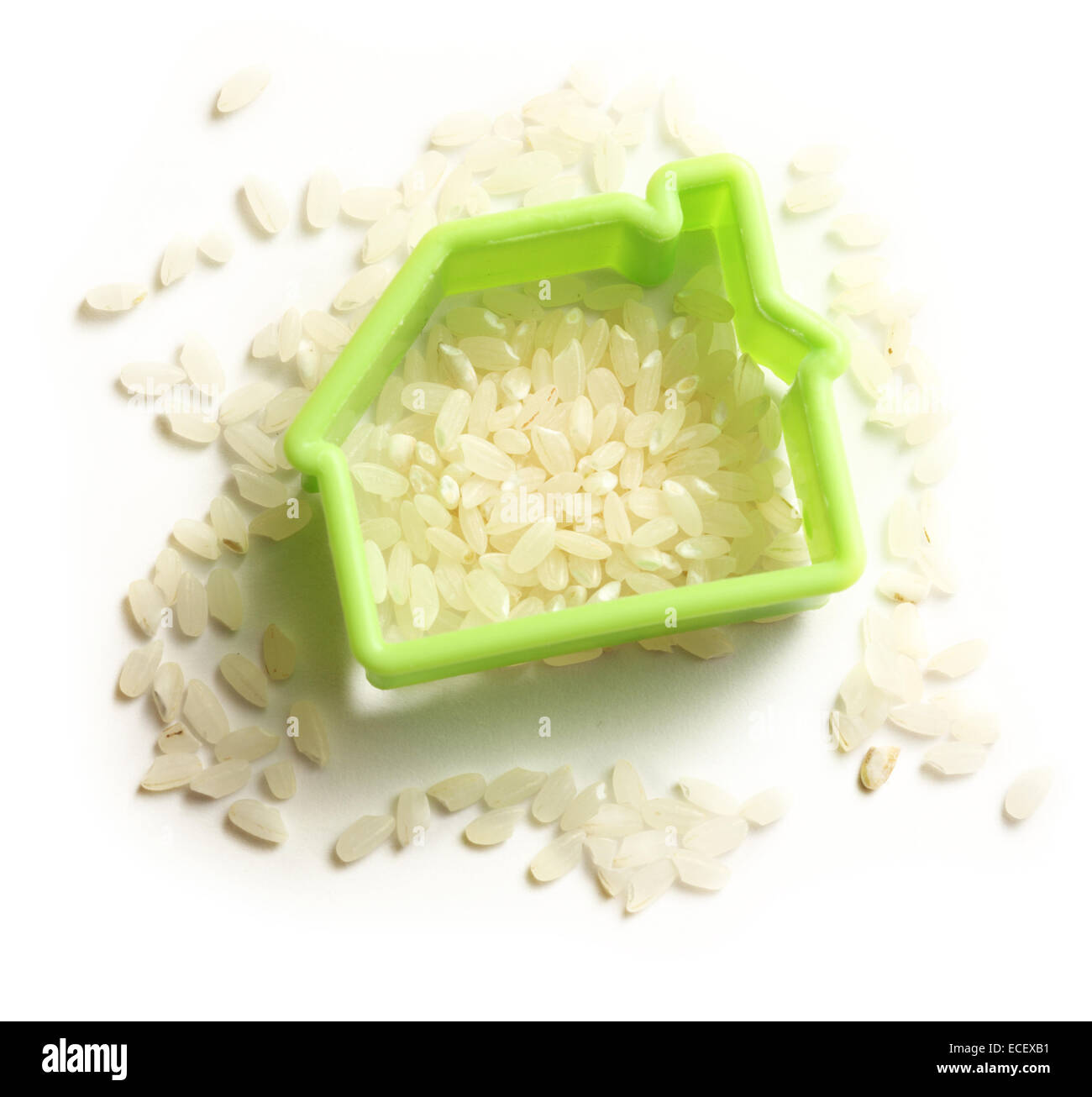 Heap of rice and home image form on white Stock Photo - Alamy