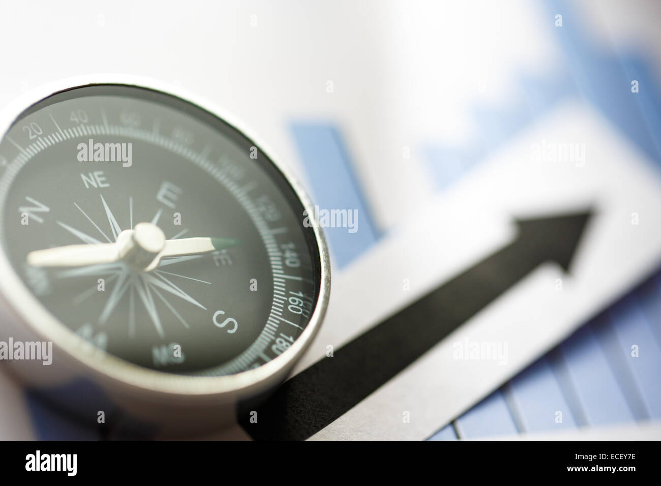Diagram concept with compass and arrow in blue toning Stock Photo - Alamy