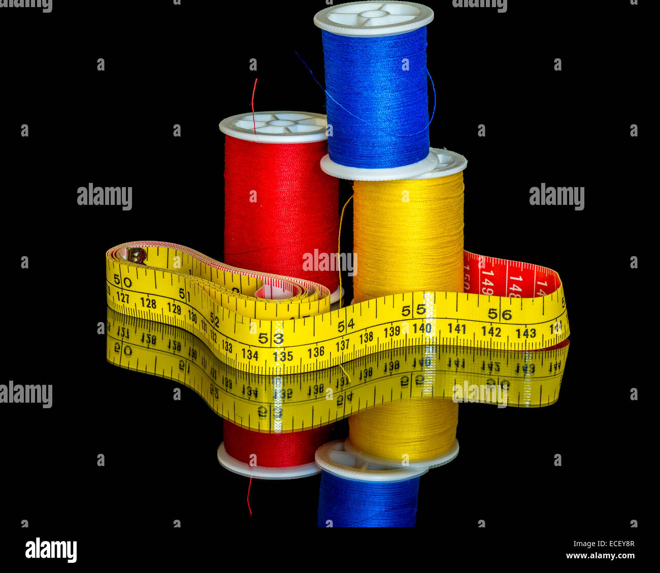 Stacked spools of thread and a measuring tape Stock Photo - Alamy