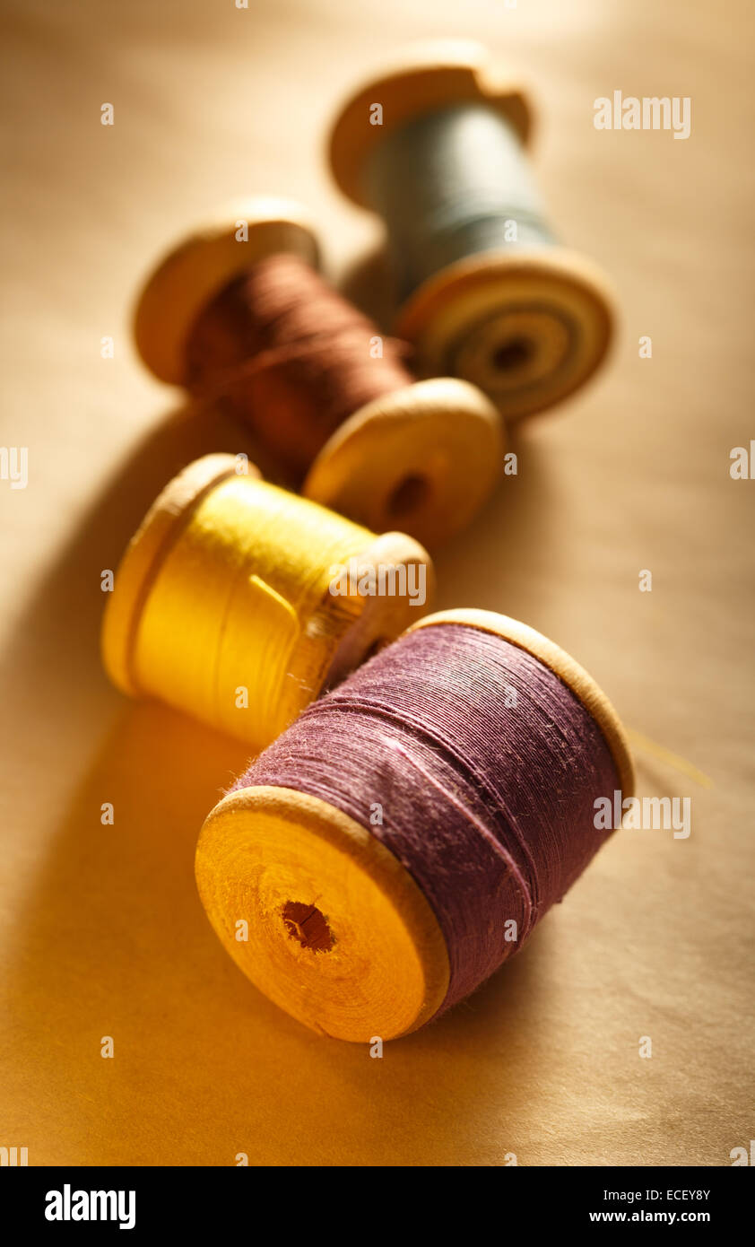 Thread bobbins on paper background Stock Photo - Alamy