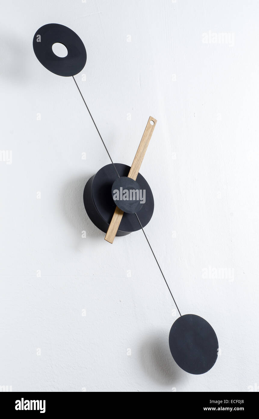 Modern clock hanging on a wall Stock Photo - Alamy