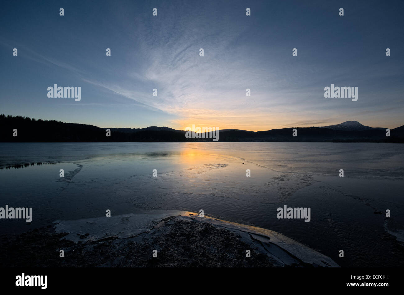 Stunning sunset over Loch Ard with the Loch being frozen in the Loch ...