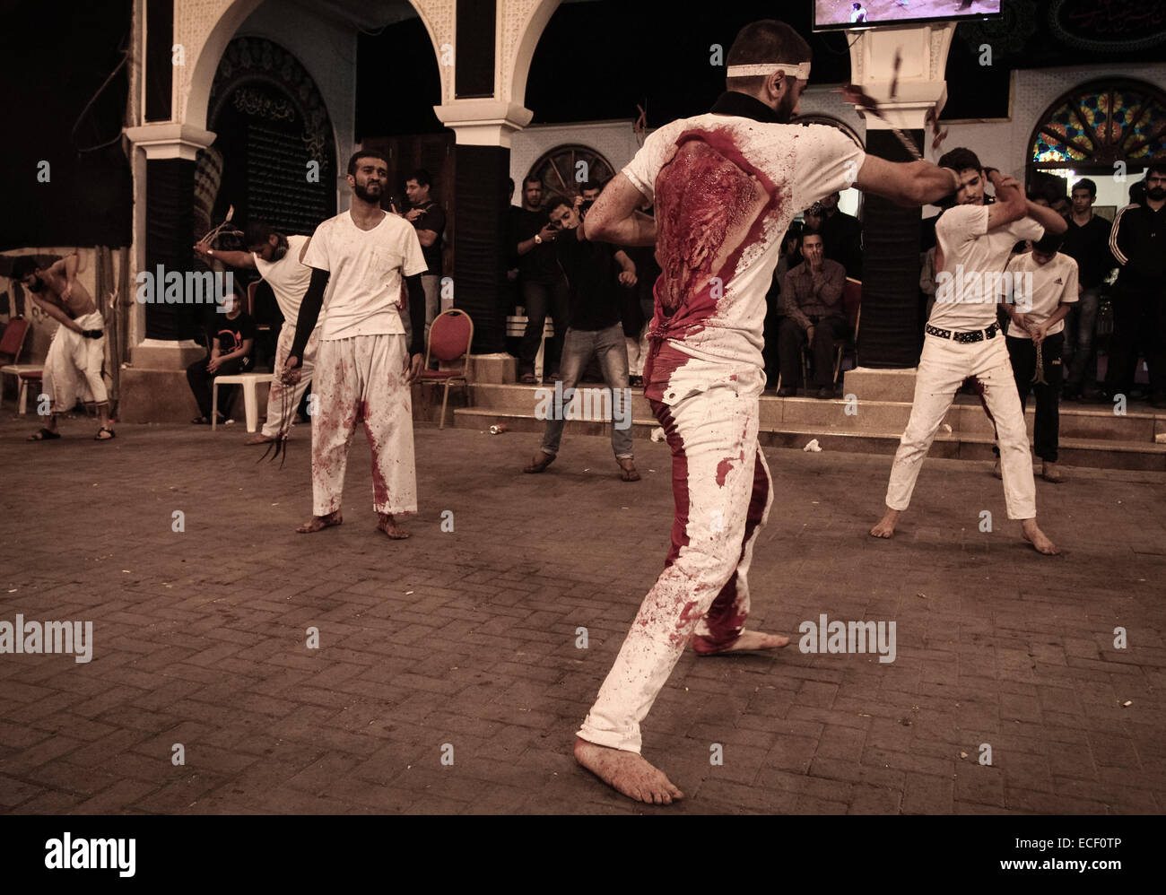 Male Shia Muslims take part in ceremonial chest beating parade as a ...
