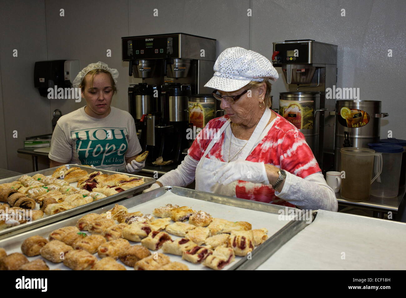 Portraits of the visitors and volunteers of the community kitchen at an ...