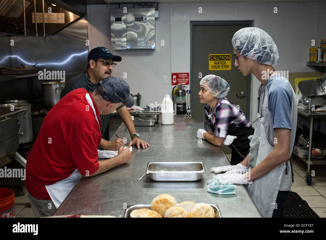 Portraits of the visitors and volunteers of the community kitchen at an ...