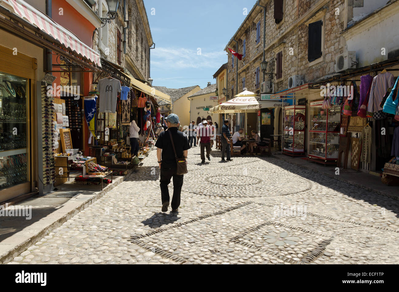 MOSTAR, BOSNIA AND HERZEGOVINA - MAY 18, 2013: A tourist walks along a ...