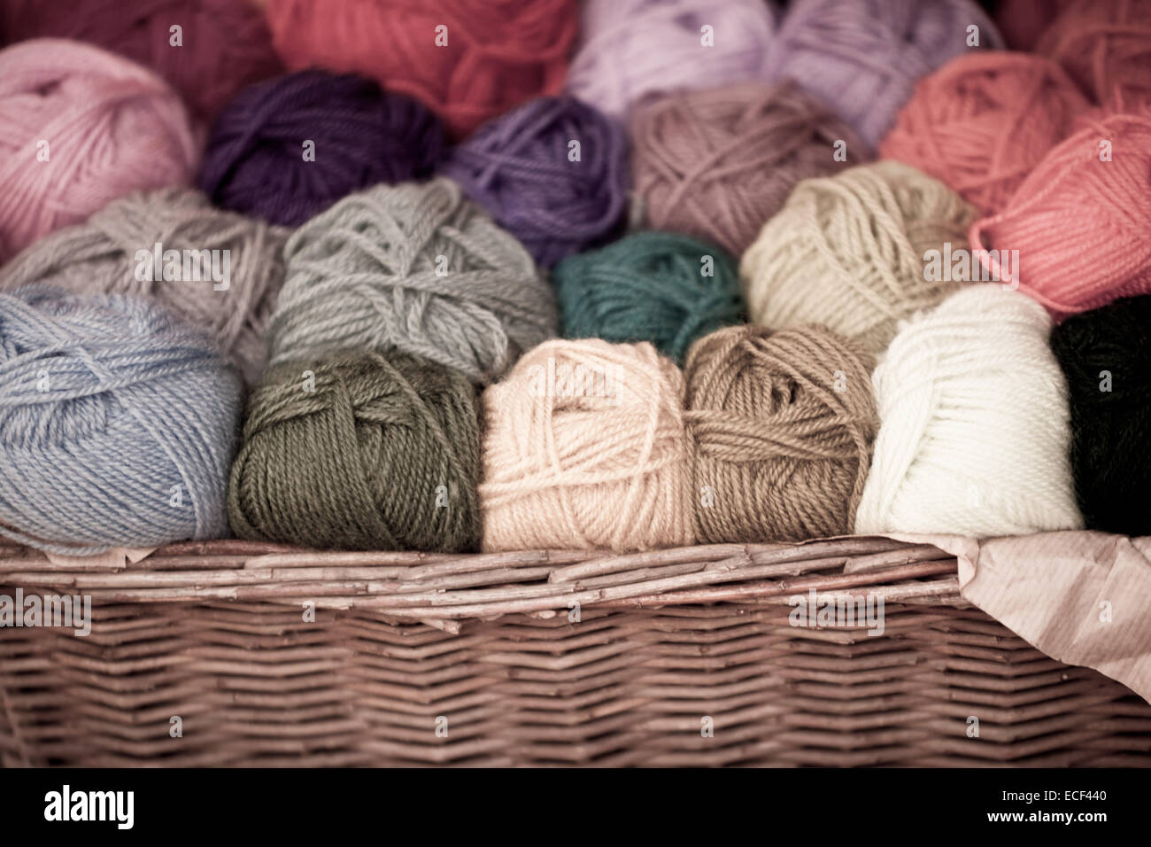Colorful different wool thread balls in wicker basket. Shot with ...