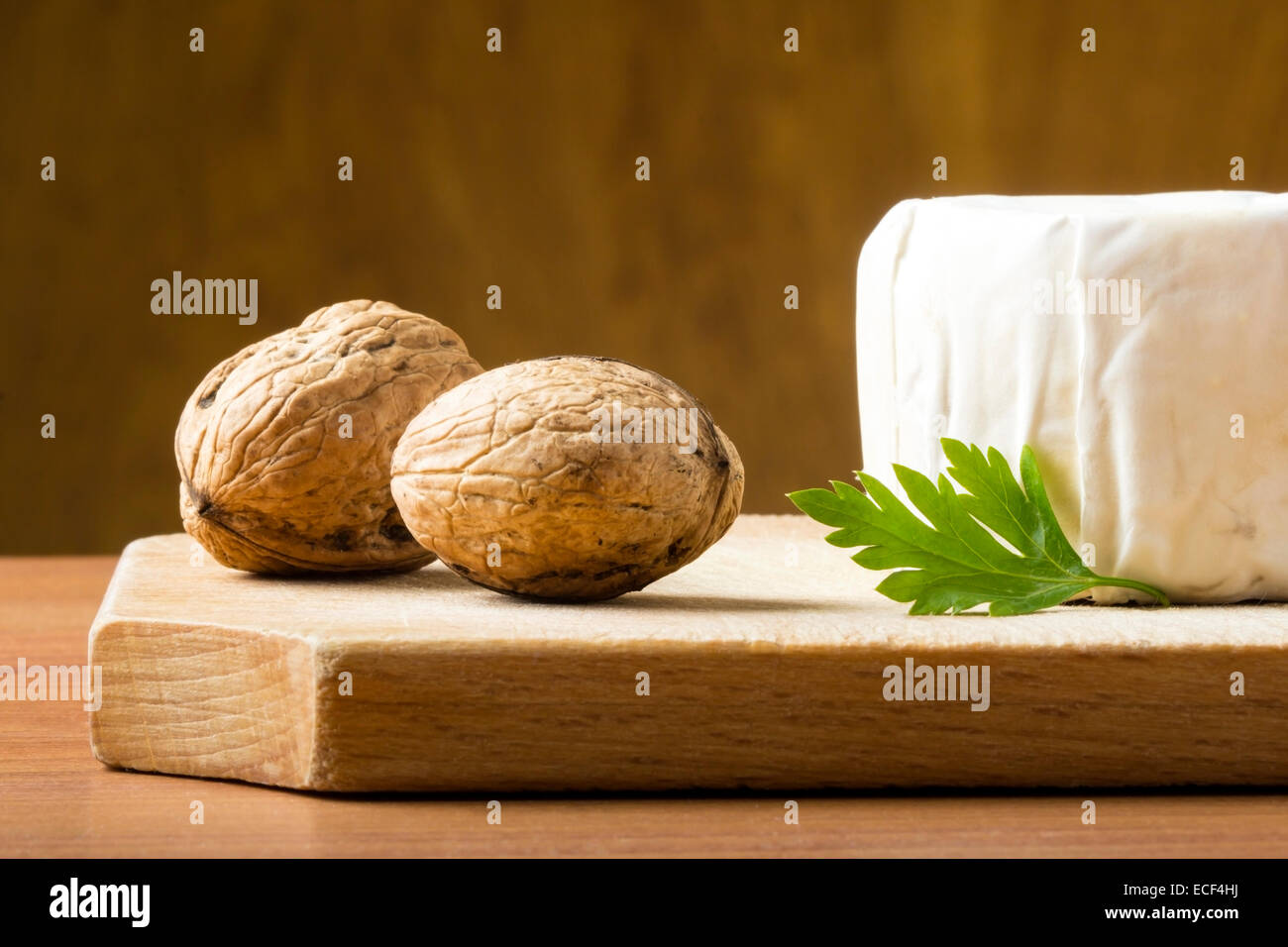 Close-up of blue cheese and walnuts on wood cheese board Stock Photo ...