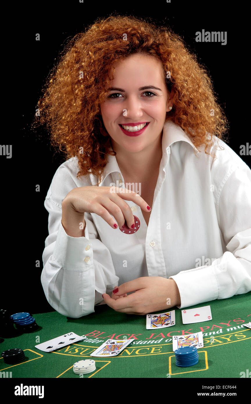 young woman croupier at the green table, while dealing the cards Stock ...