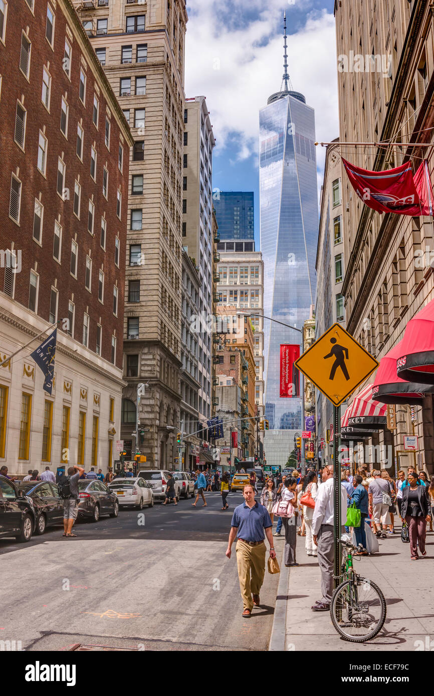 A busy street in Downtown Manhattan is dwarfed by World Trade Center ...