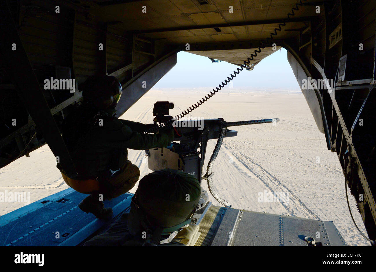 A tail gunner mans a heavy machine gun in a German Air Force CH-53 ...