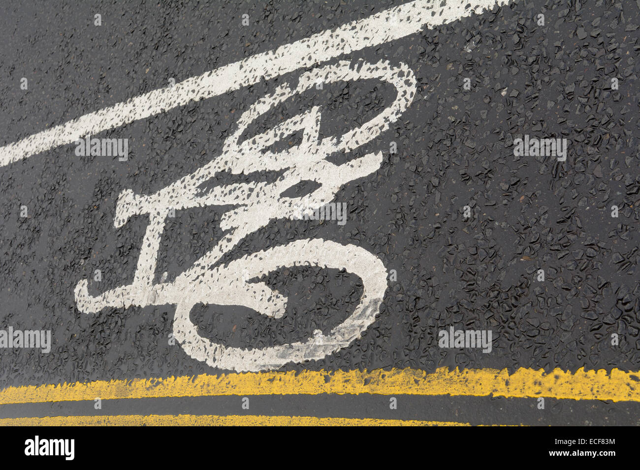 Cycle lane symbol and yellow lines on road Stock Photo - Alamy