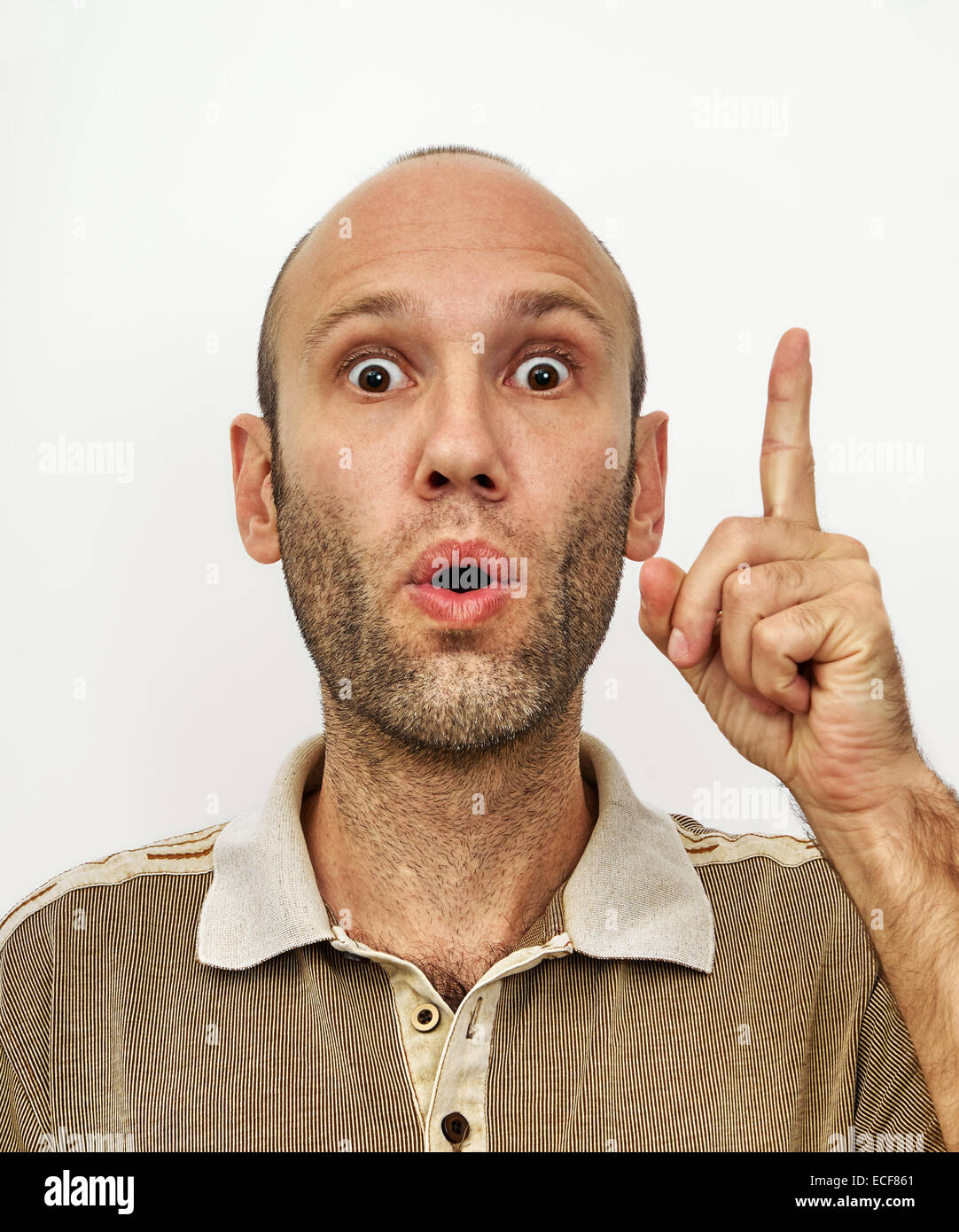 Amazed wide-eyed man showing forefinger Stock Photo - Alamy