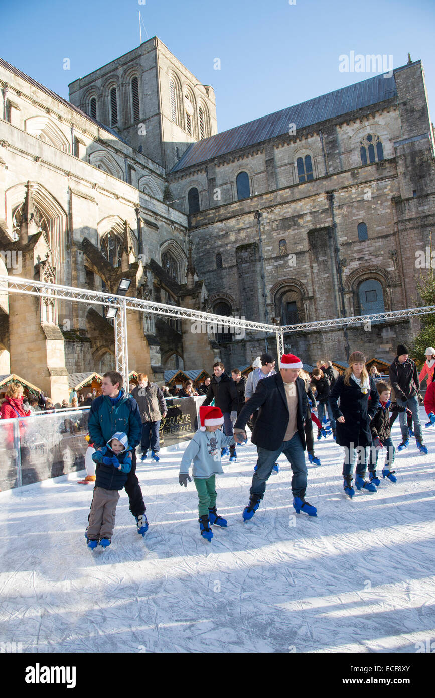 Christmas skaters on the ice rink at Winchester Cathedral Hampshire ...