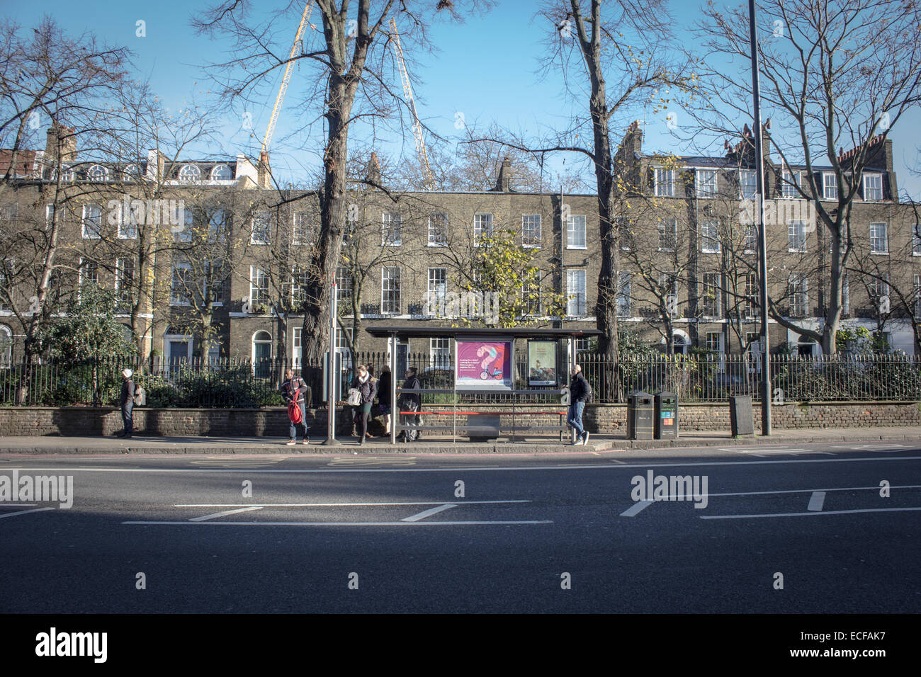 People waiting at an empty bus stop in London near Highbury/ Islington ...