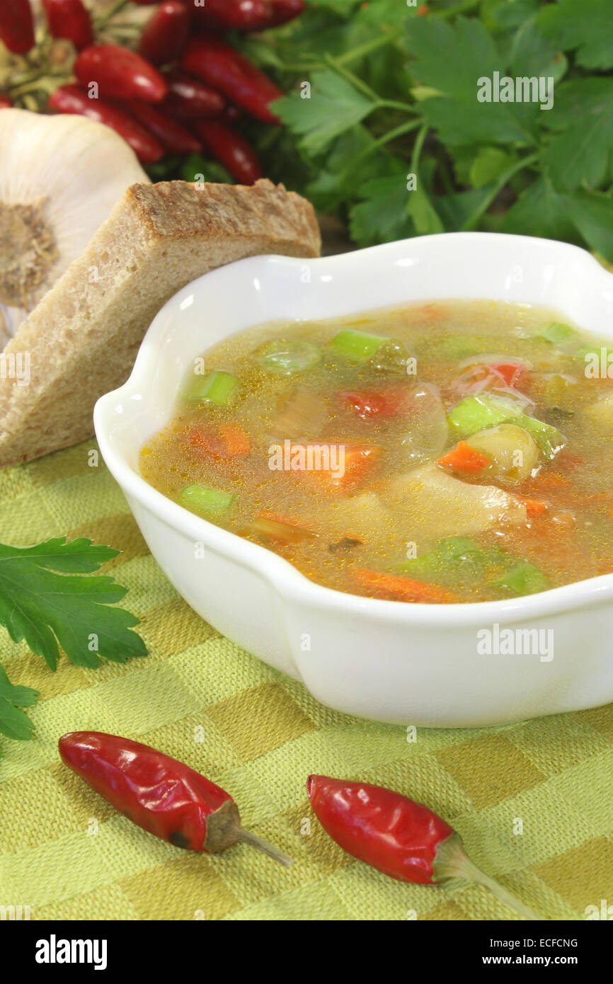 Poultry consomme soup with green, smooth parsley and bread Stock Photo ...