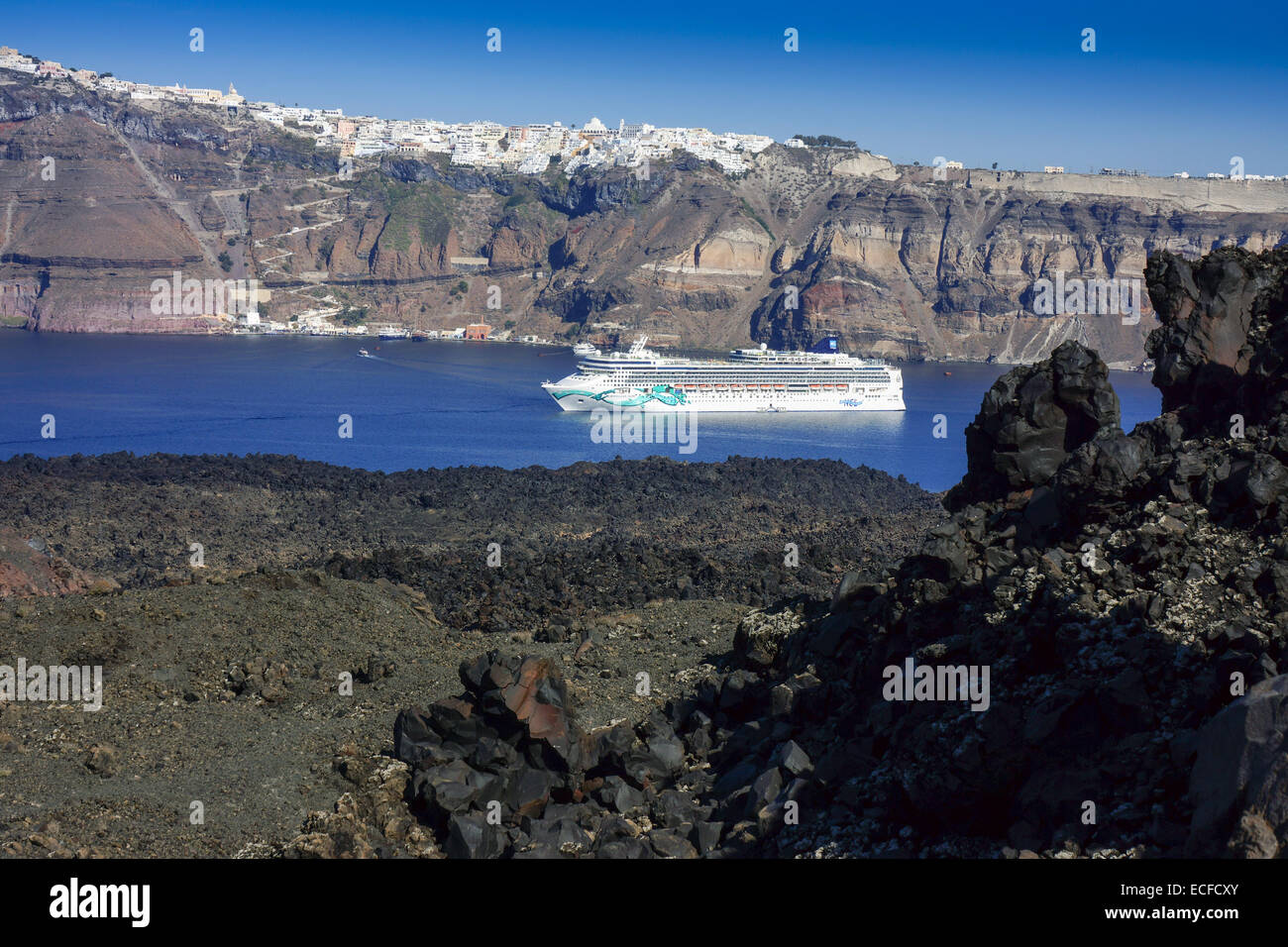 Cruise liner Norwegian Jade below cliffs and white houses, Santorini ...
