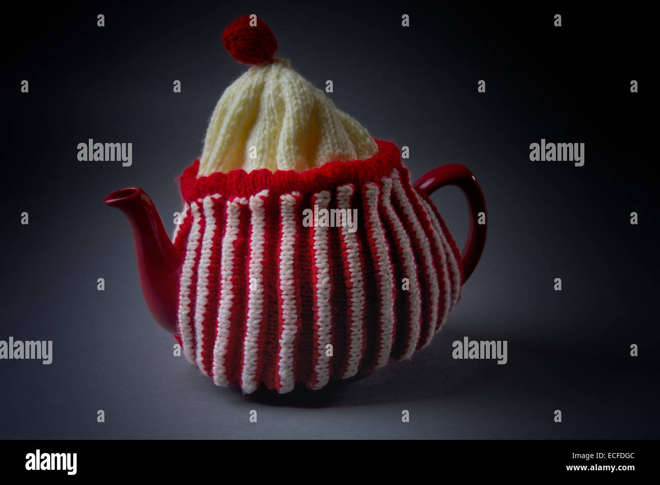Red teapot with knitted tea cozy Stock Photo - Alamy