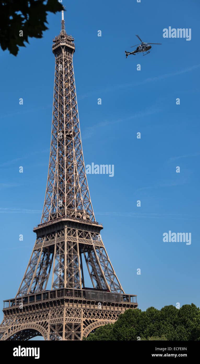 A helicopter flies past the Eiffel Tower in Paris France Stock Photo ...