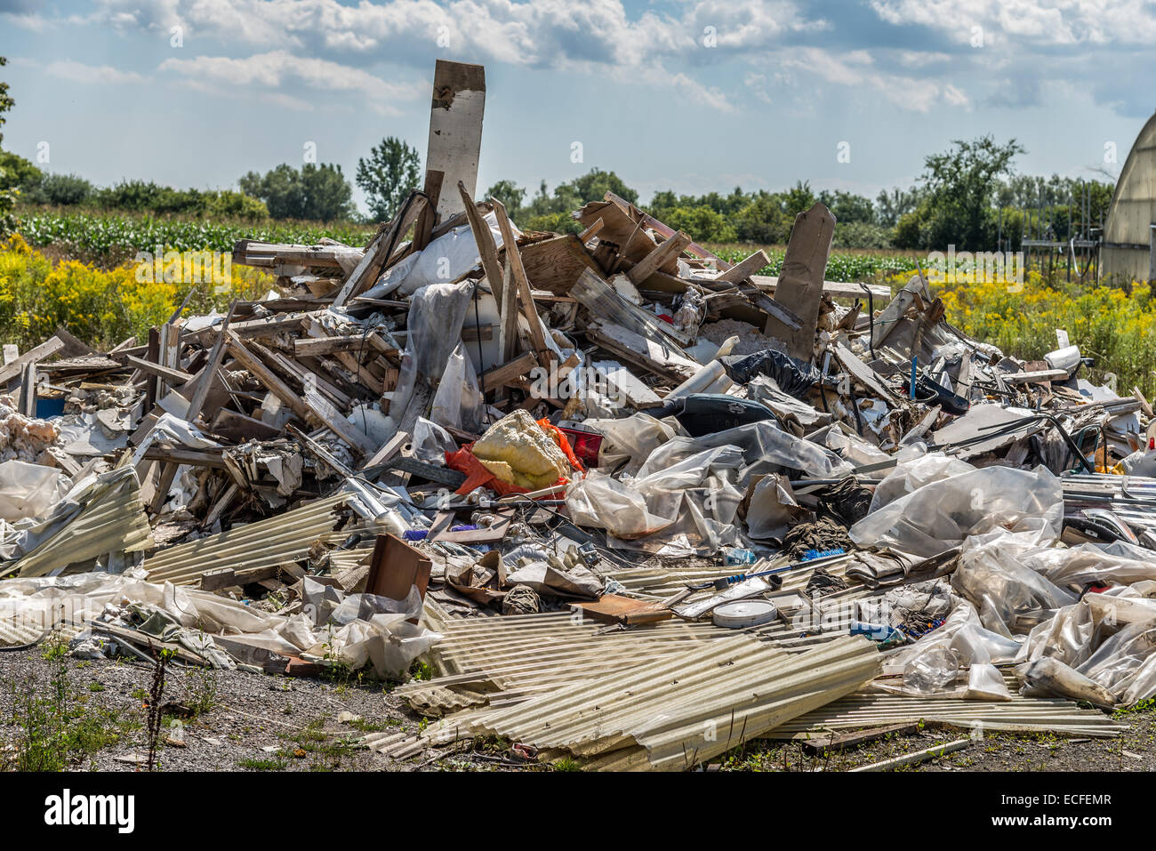 A pile of trash illegally dumped in a farmers field Stock Photo - Alamy