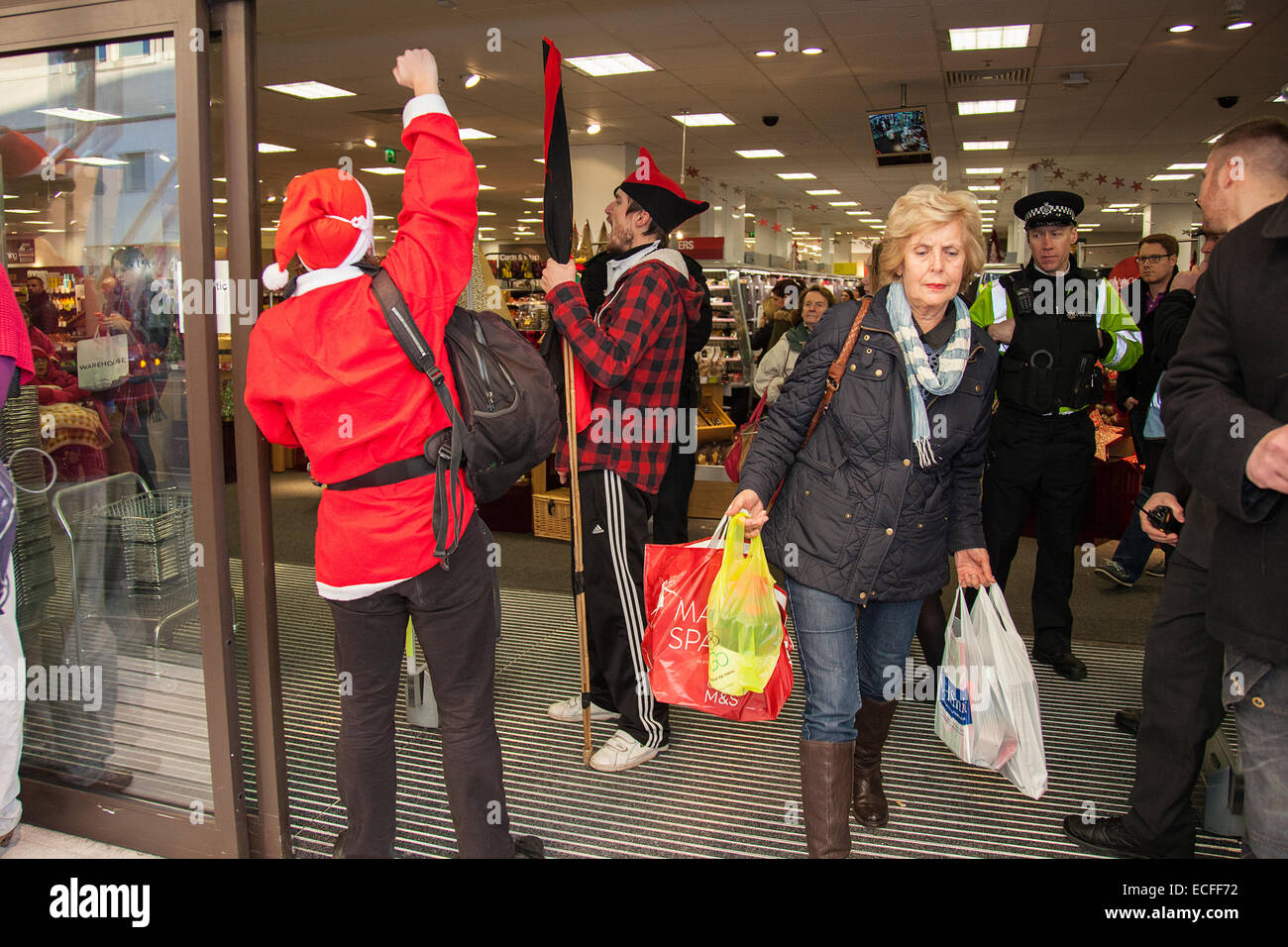 Bristol, UK. 13th December, 2014. Campaigners dressed as Santa protest ...