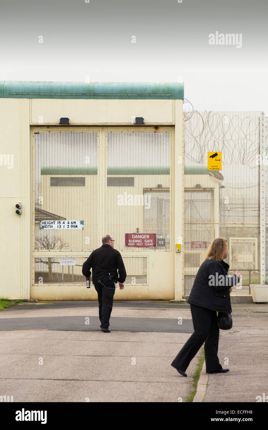 A prison guard approaches the front gate of Haverigg Prison, Cumbria ...