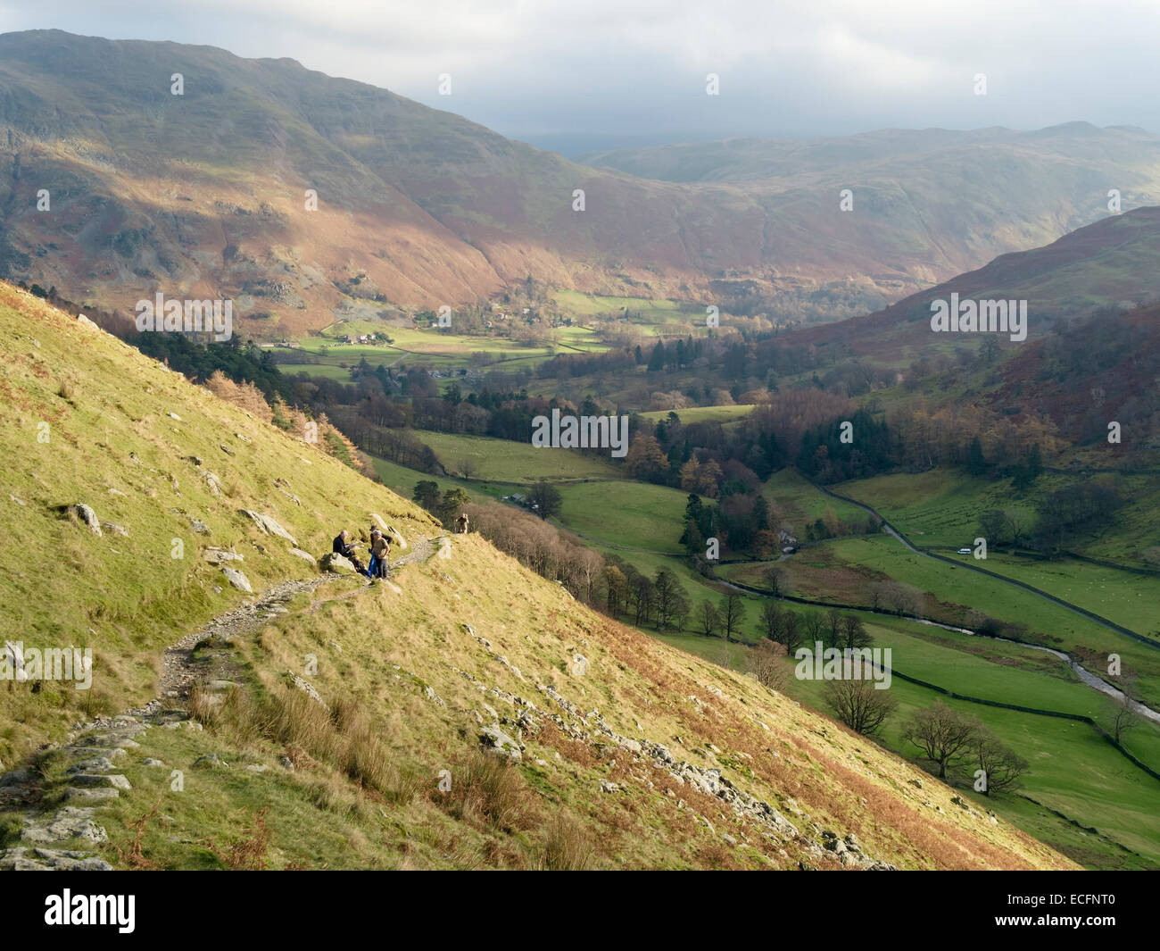 Hill walkers on path on slopes of Grisedale valley, Patterdale, Lake ...
