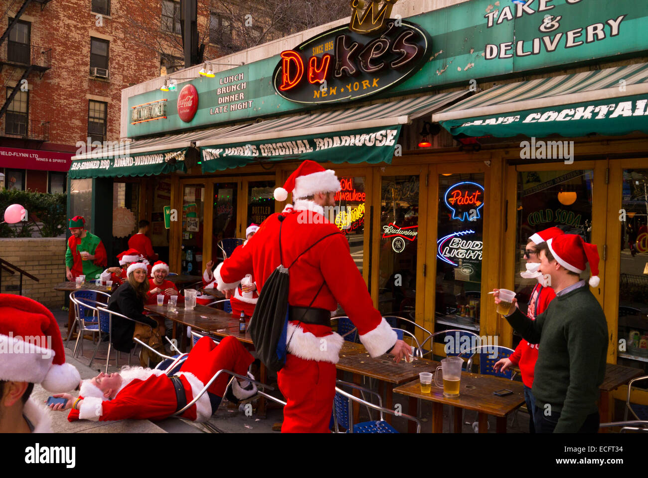 New York, USA. 13th December, 2014. Revelers dressed as Santa Claus ...