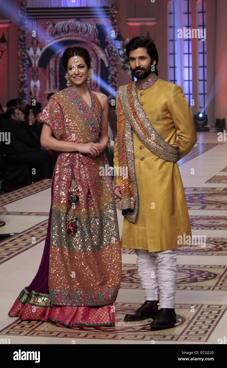 Lahore. 13th Dec, 2014. Models present creations designed by Umar Saeed ...