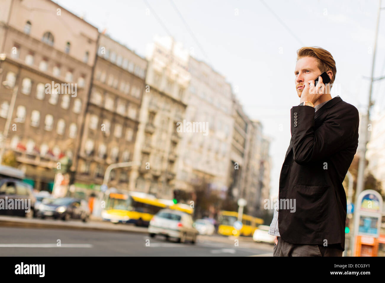 Young man on the street with mobile phone Stock Photo - Alamy