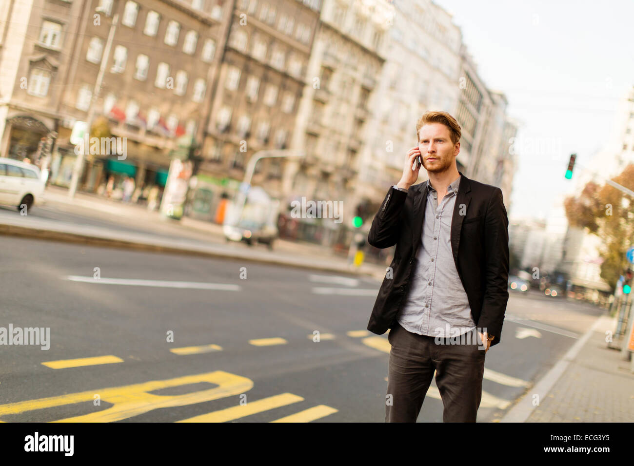 Young man on the street with mobile phone Stock Photo - Alamy