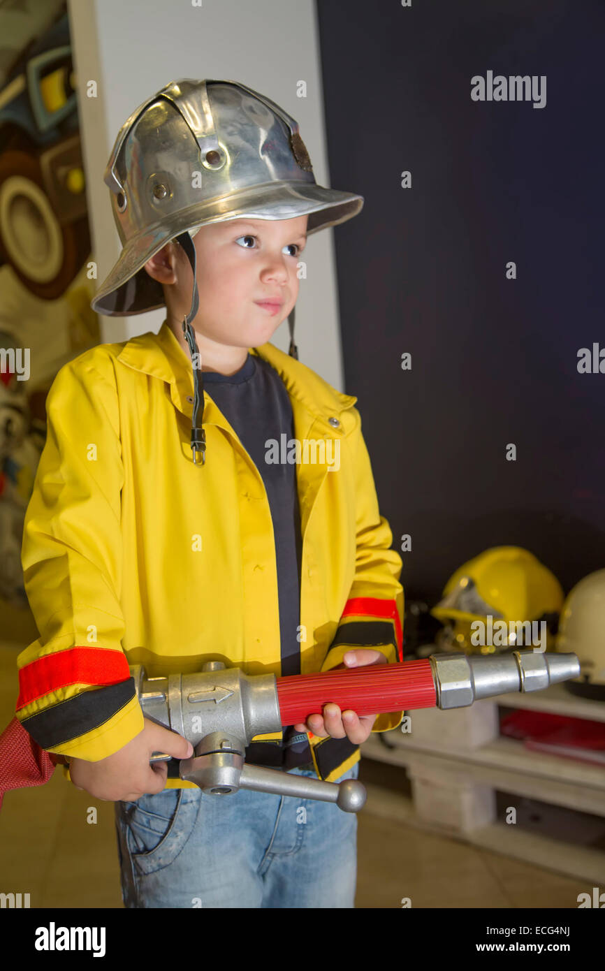 Cute little boy dressed as firefighter Stock Photo - Alamy
