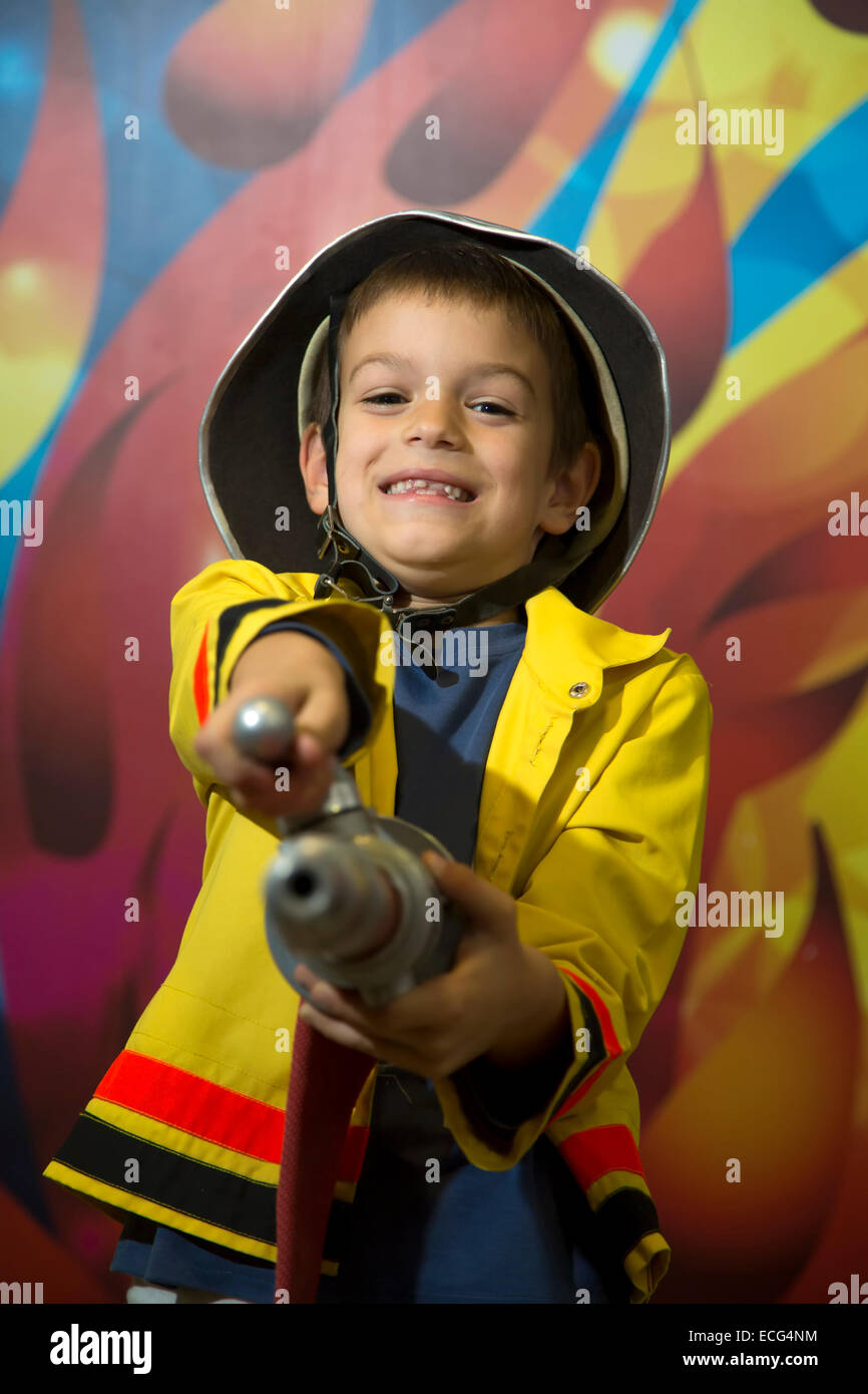Cute little boy dressed as firefighter Stock Photo - Alamy