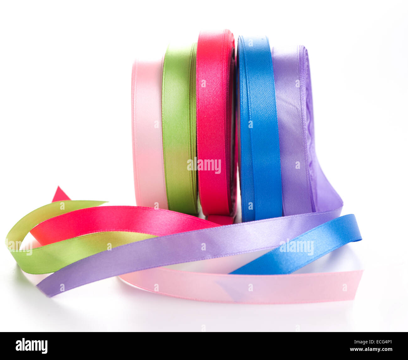 colored satin ribbons in a roll isolated on white background Stock ...