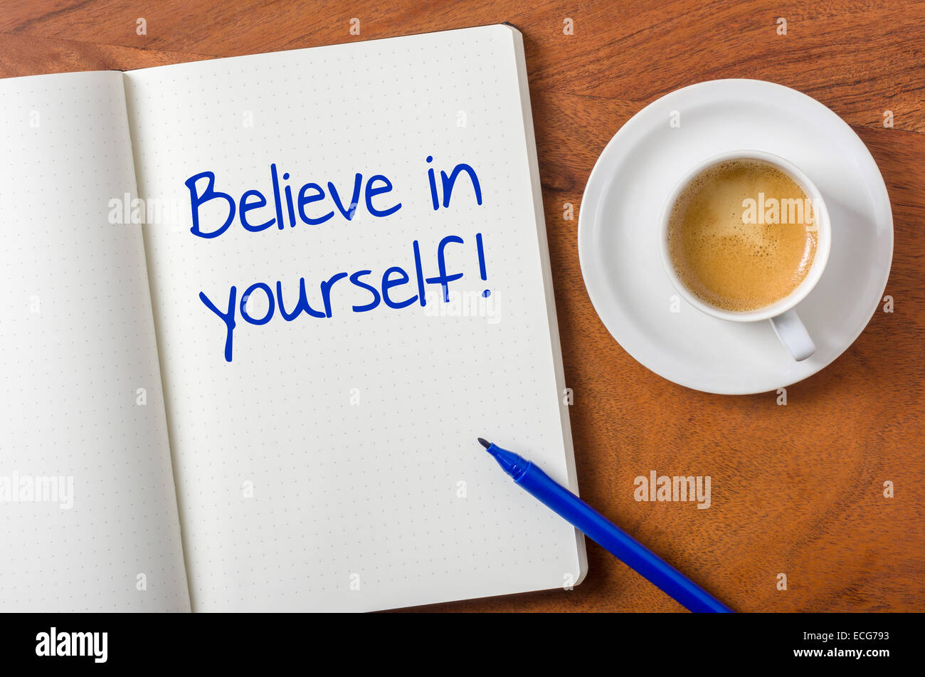 Notebook on a desk - Believe in yourself Stock Photo - Alamy