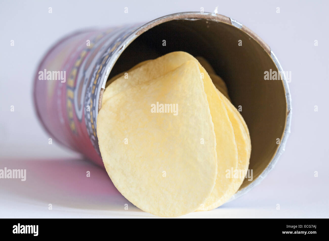 open tub of Pringles Original with contents spilled on white background ...