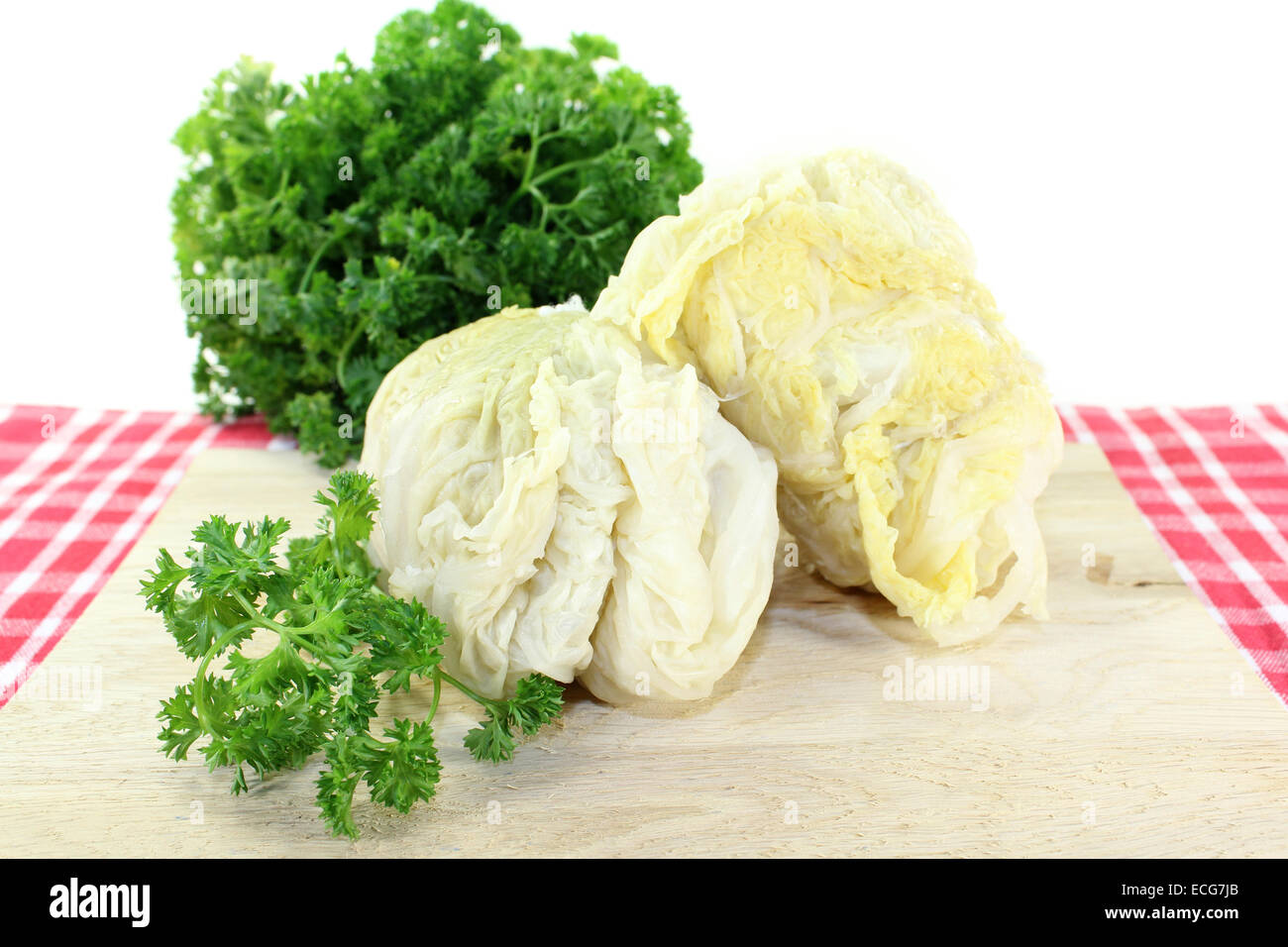 Savoy cabbage roulade with parsley against white background Stock Photo ...