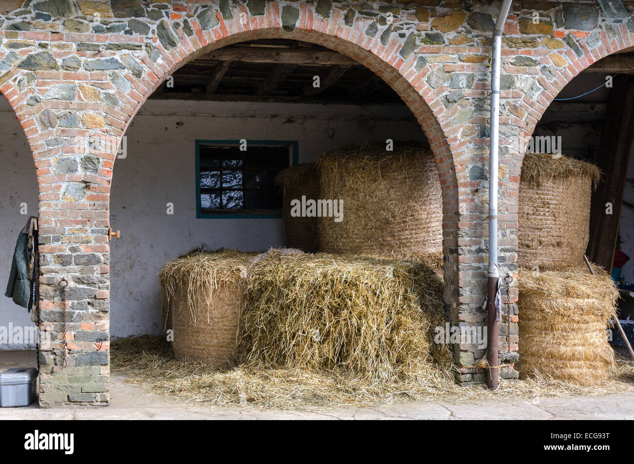 bales of hay in a barn brick Stock Photo - Alamy