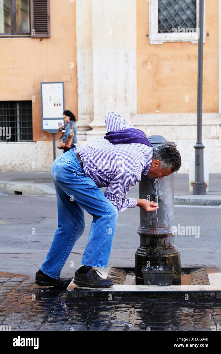 Person drinking water from the fountain tap in the street, Rome, Italy ...