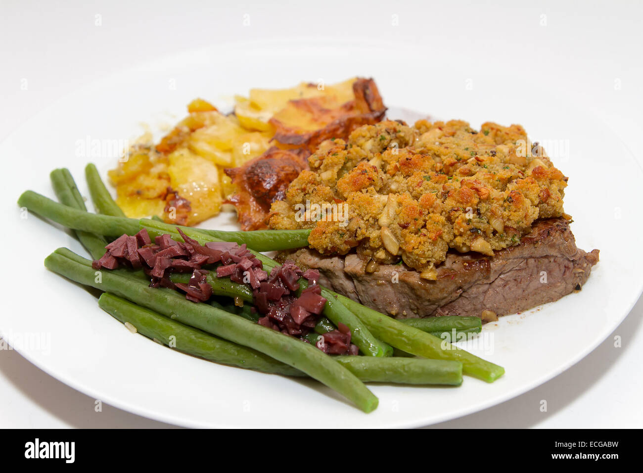 Beef fillet with porcini crust, potato and beans Stock Photo - Alamy