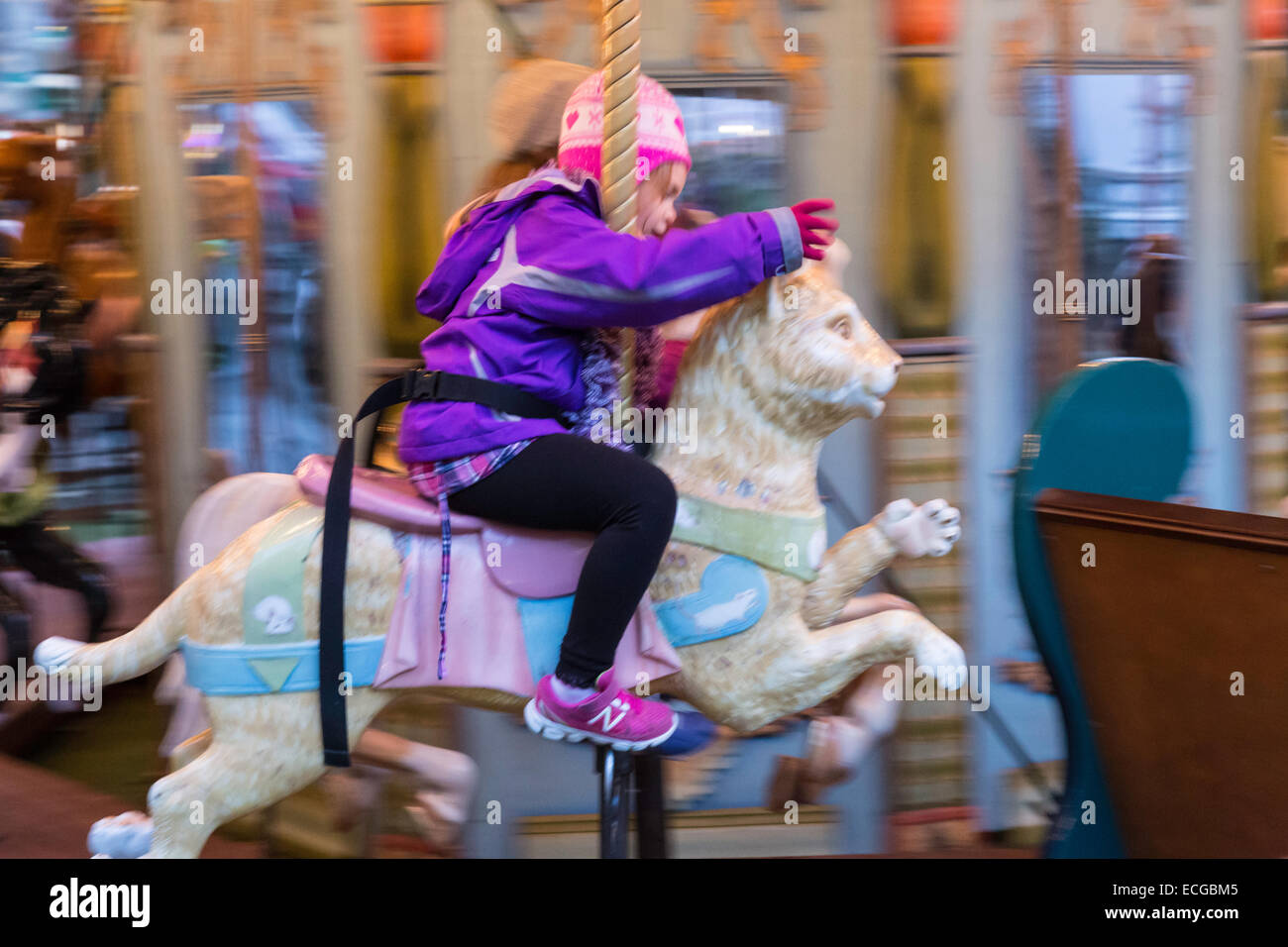 Girl riding on merry go round hi-res stock photography and images - Alamy