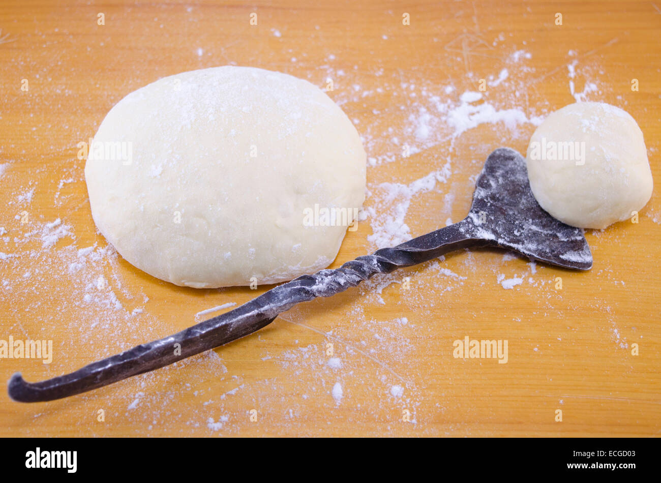 Hand kneaded dough and an old-style dough cutter placed against a ...