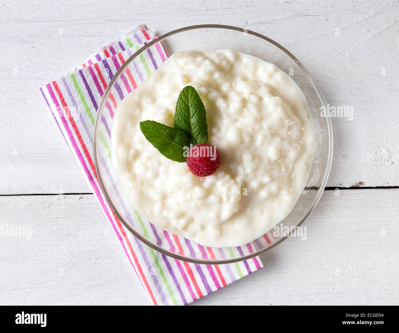 Rice pudding with mint and raspberry Stock Photo - Alamy
