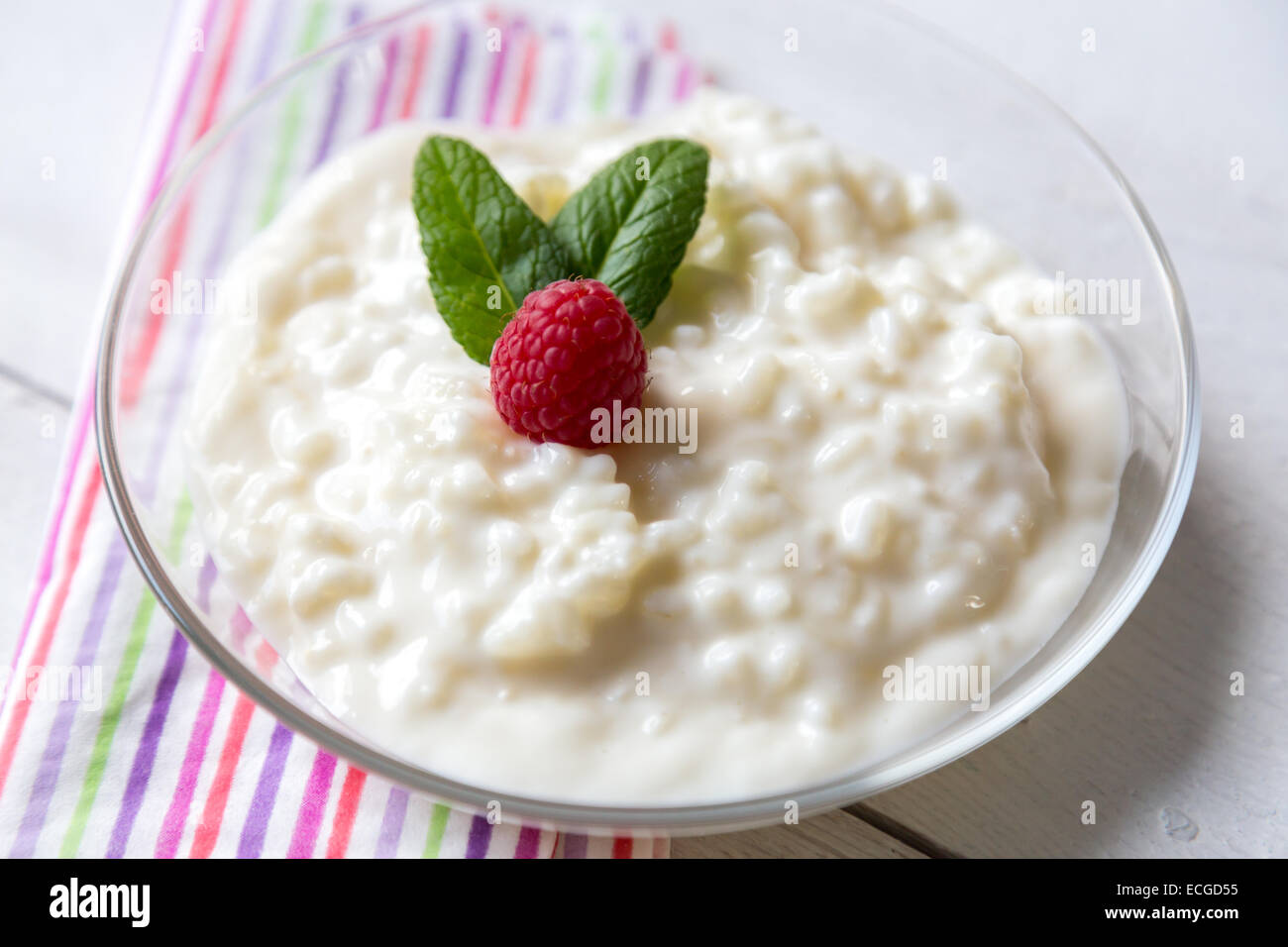 Rice pudding with mint and raspberry Stock Photo - Alamy
