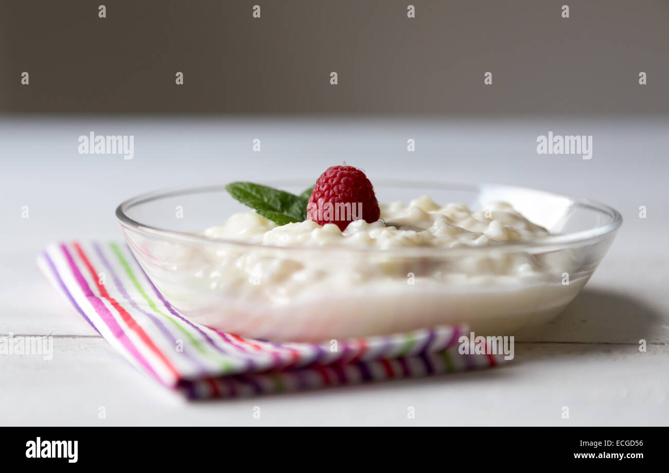 Rice pudding with mint and raspberry Stock Photo - Alamy