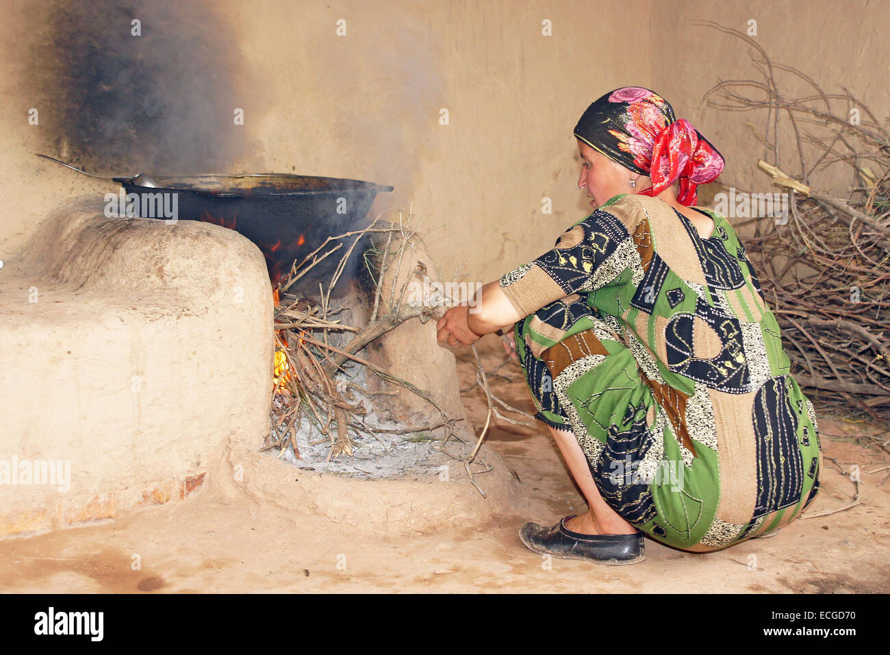 HISSAR MOUNTAINS, UZBEKISTAN - MAY 24, 2012: Woman cooking on ...