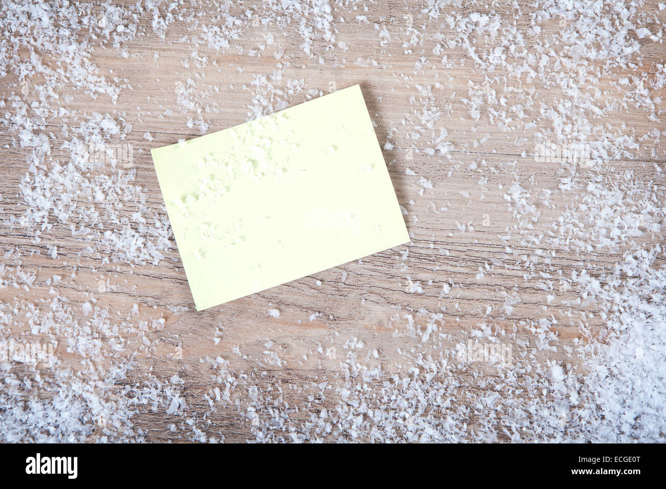 on a wooden background a yellow Sticky note with no text. Decorated ...