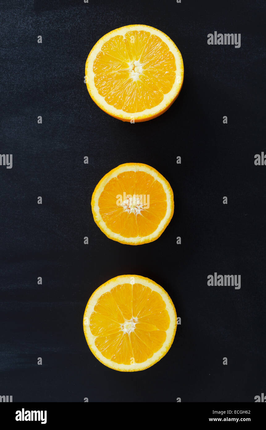 Orange fruits over black chalkboard with handwritten "oranges" word ...