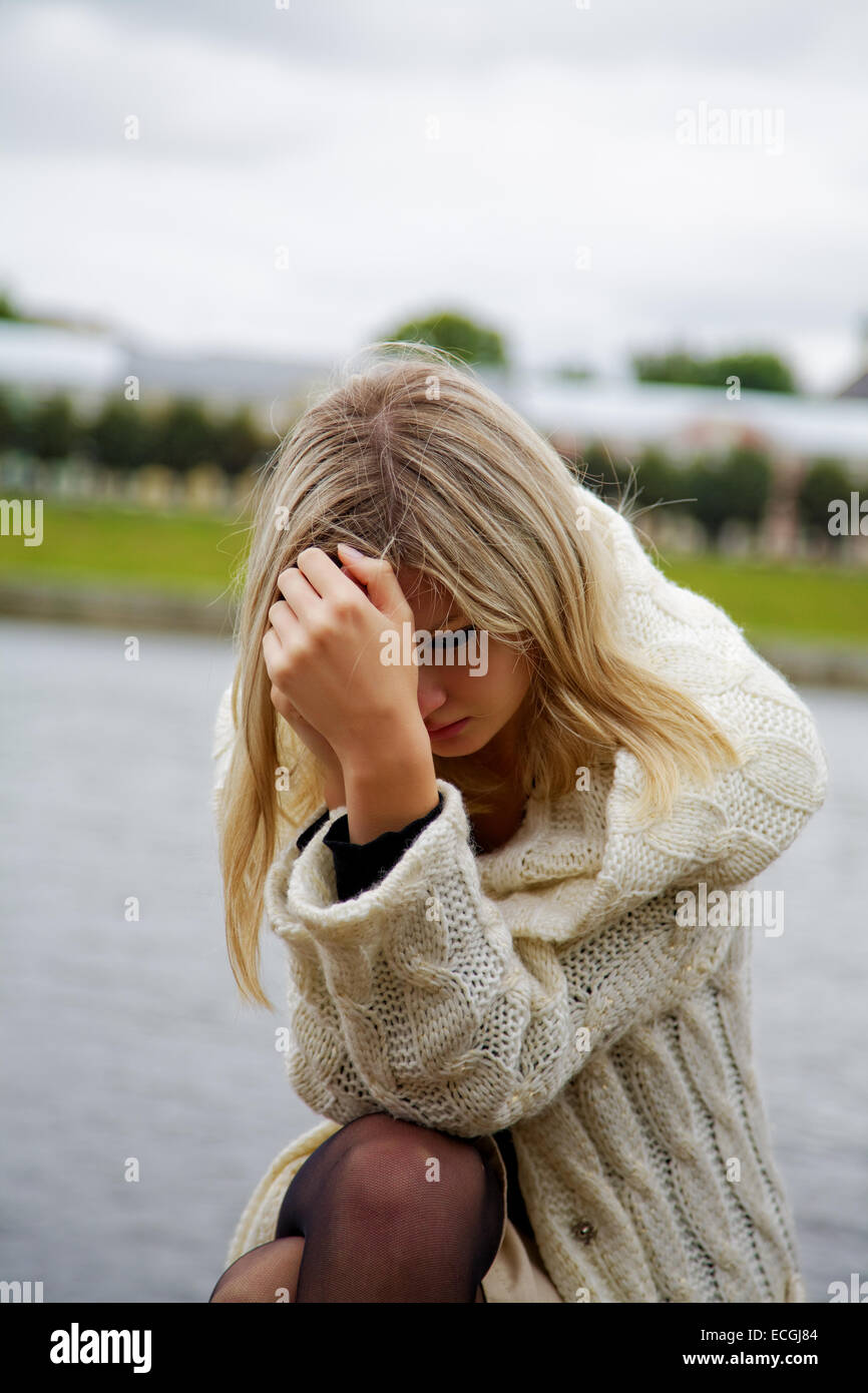 The girl in despair and grief against the river Stock Photo - Alamy